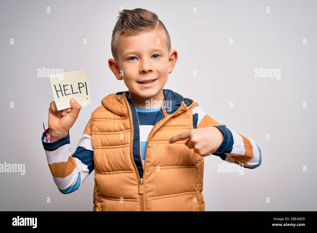 Young little caucasian kid asking for help on a paper note as violence ...