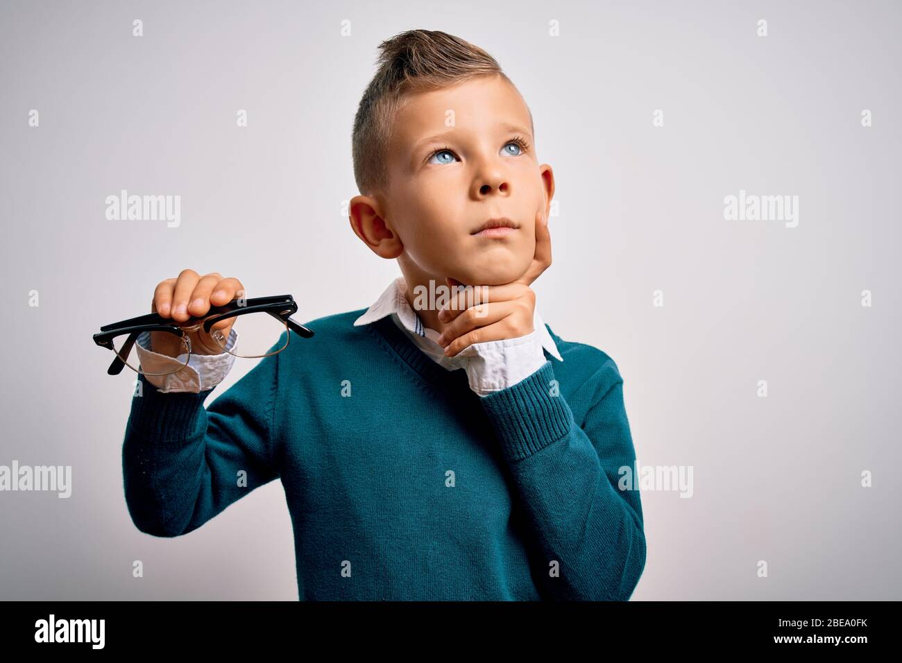 Young little caucasian kid holding eyesight glasses correction over ...