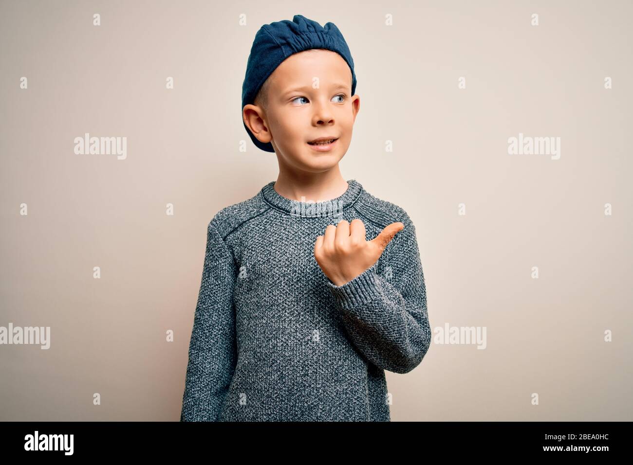 Young little caucasian kid with blue eyes wearing wool cap over ...
