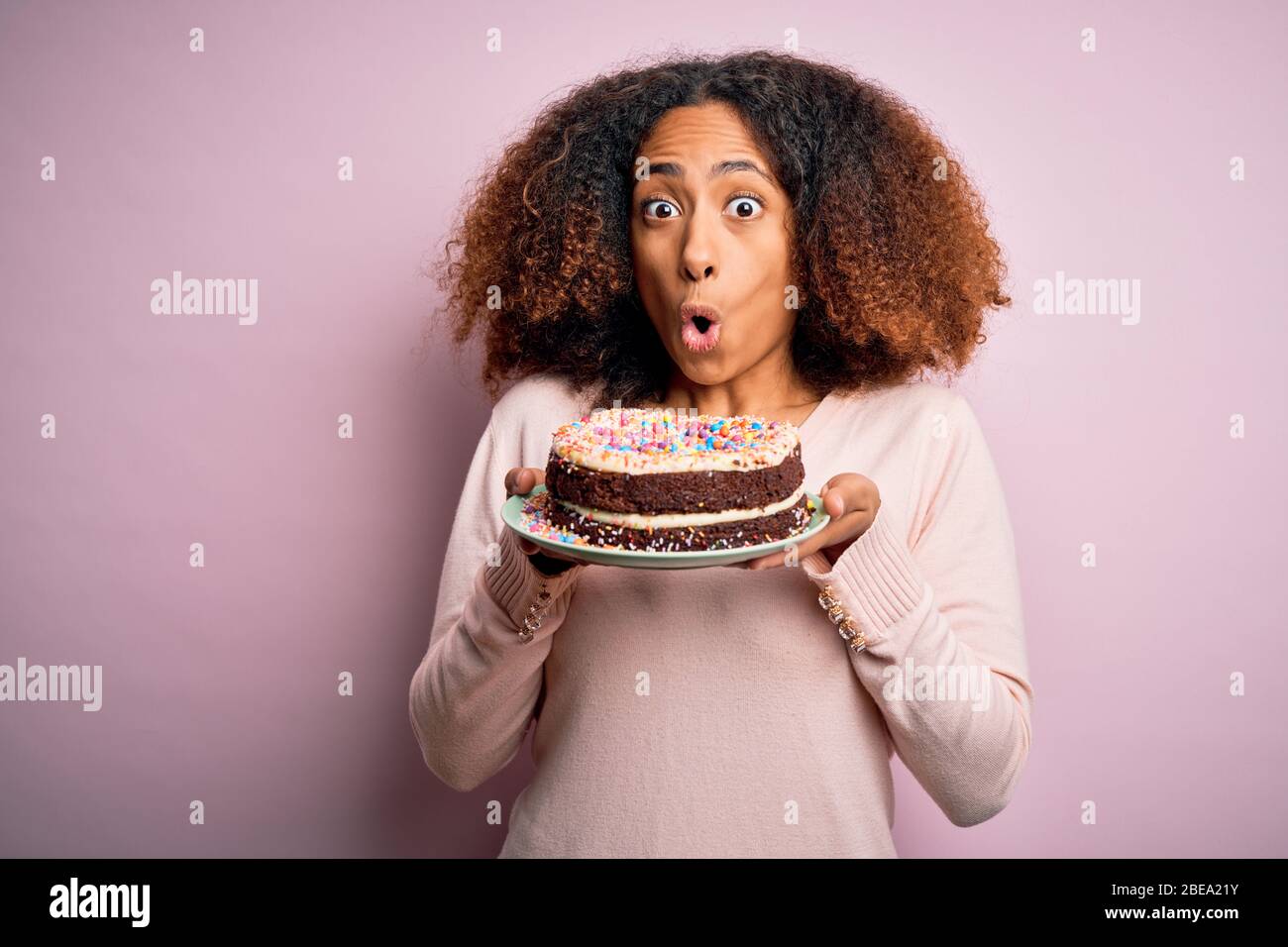 Young african american woman with afro hair holding delicious birthday ...