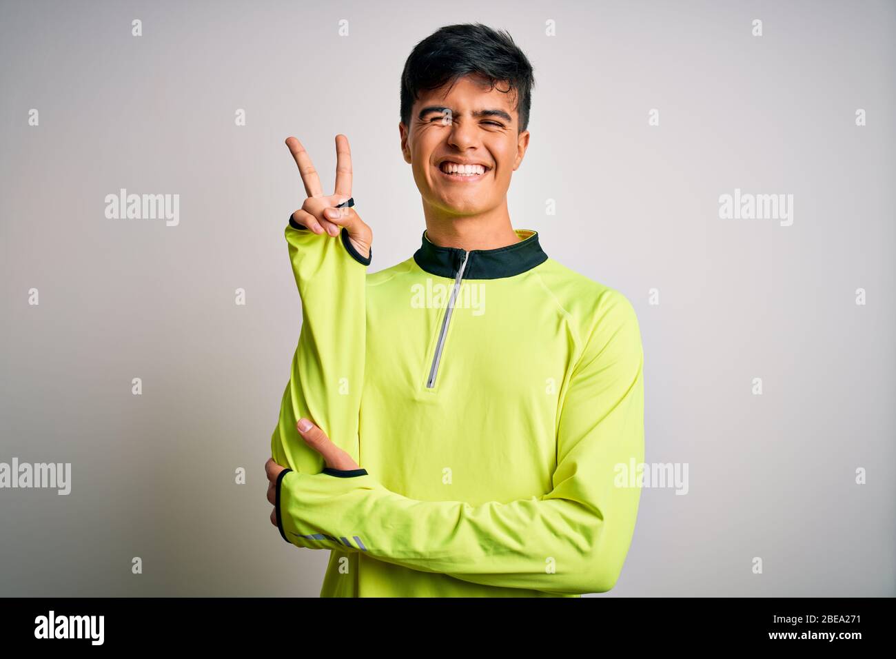 Young handsome sportsman doing sport wearing sportswear over isolated ...