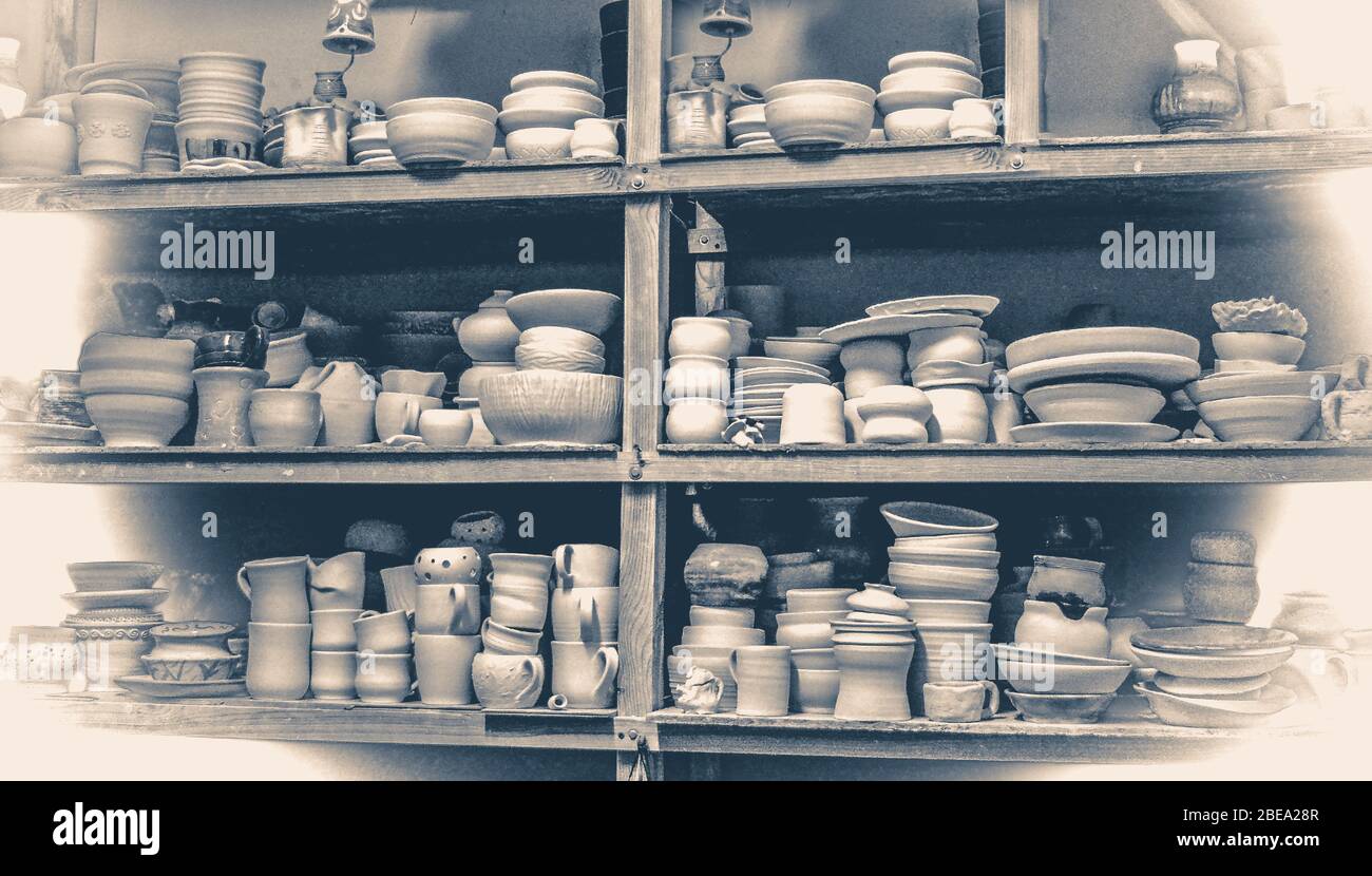 Old vintage style photo. Many different pottery standing on the shelves ...