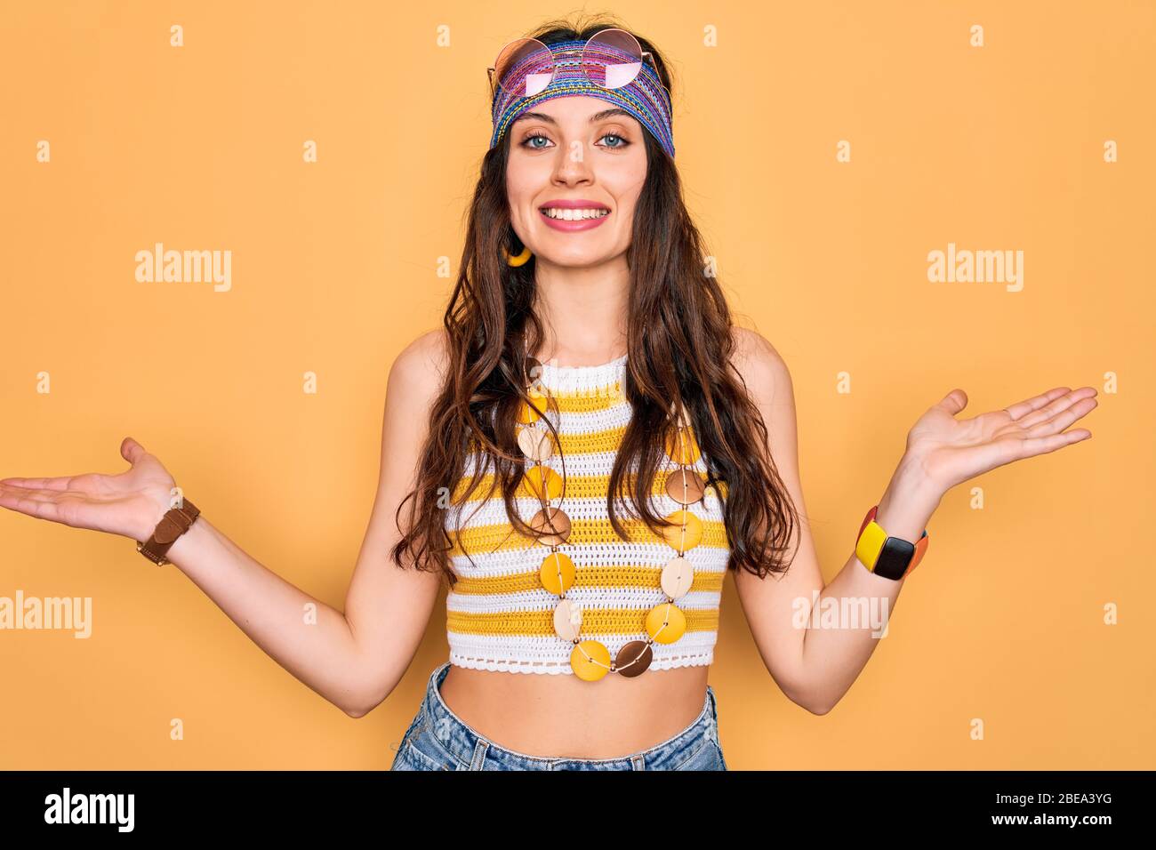 Young beautiful hippie woman with blue eyes wearing accesories and ...