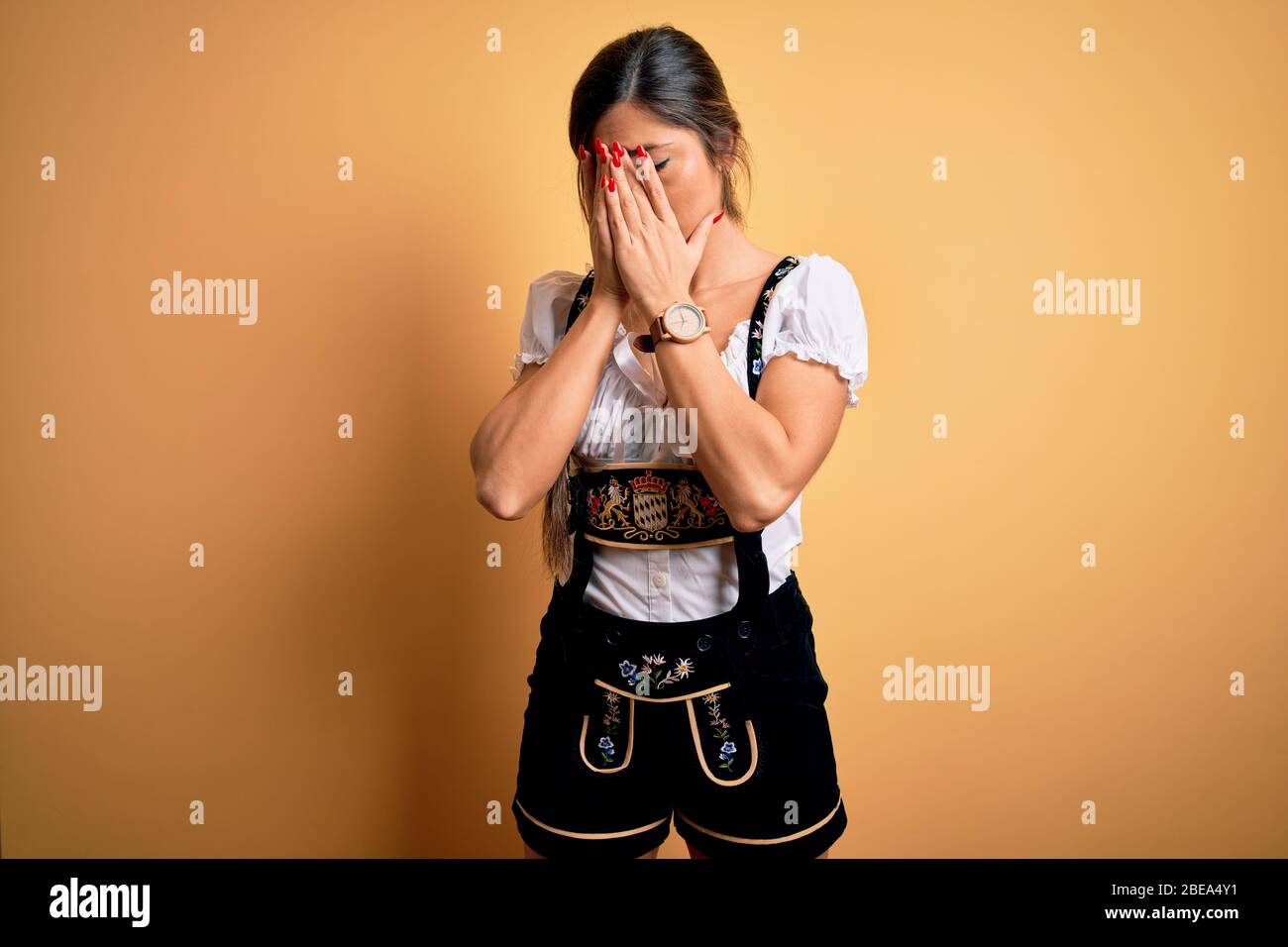 Young beautiful brunette german woman celebrating Octoberfest wearing ...