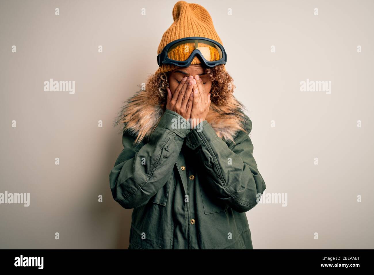 Young african american skier woman with curly hair wearing snow ...