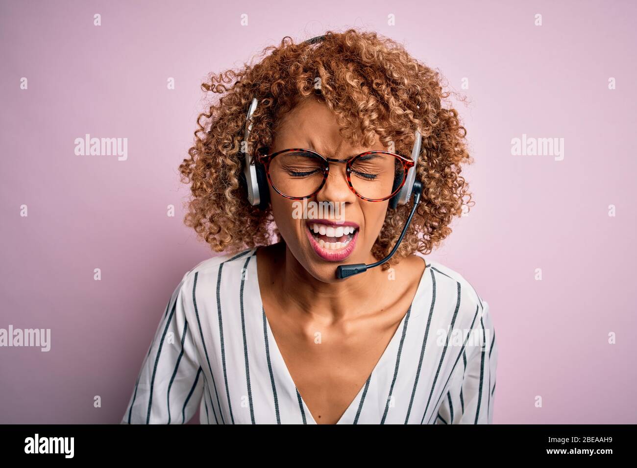 African american curly call center agent woman working using headset ...