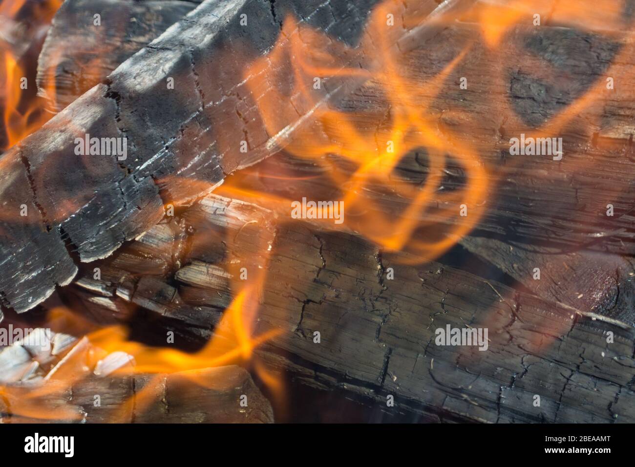 burning firewood closeup photo, black burnt wood and orange flame Stock ...