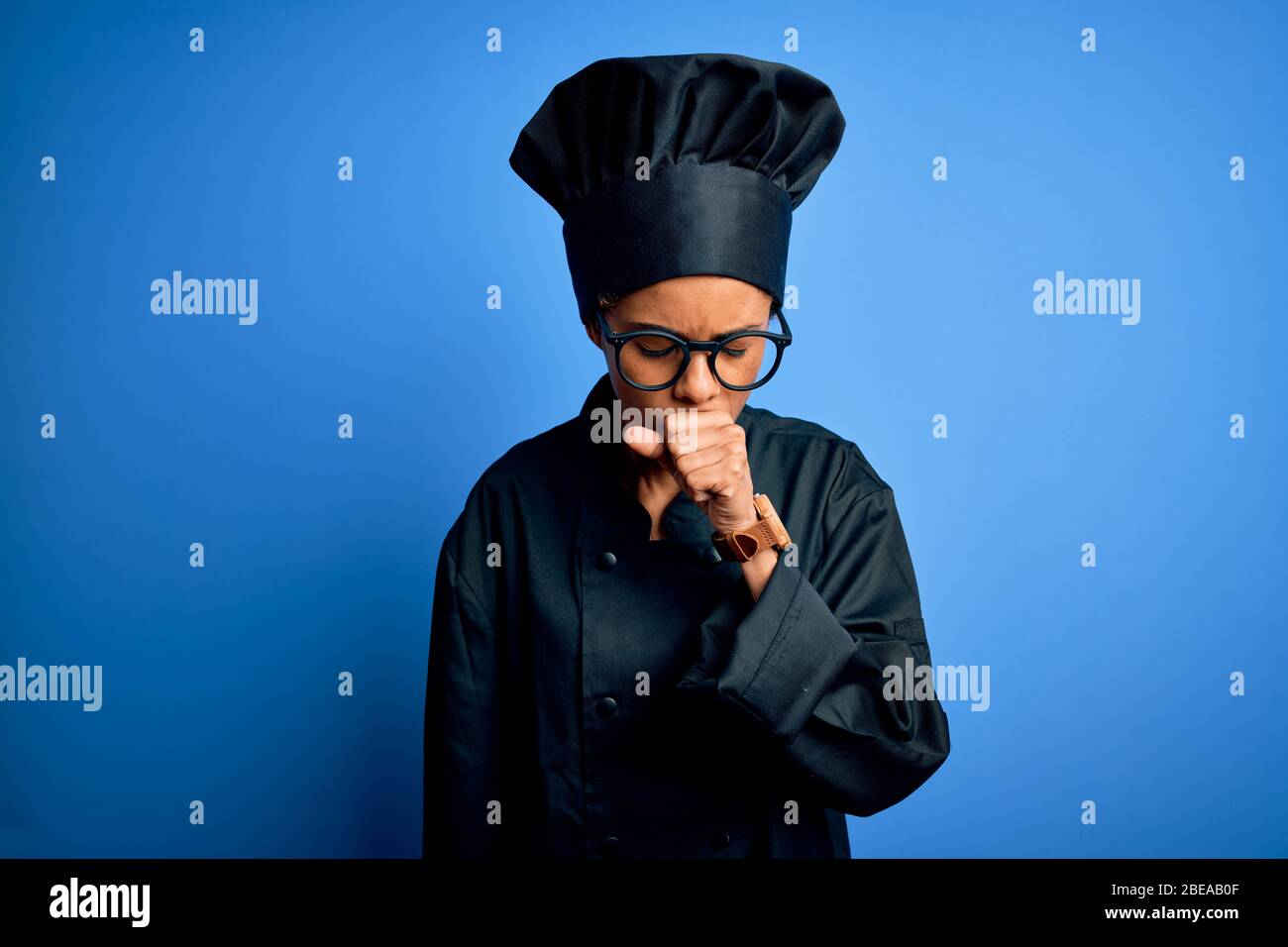 Young african american chef woman wearing cooker uniform and hat over ...