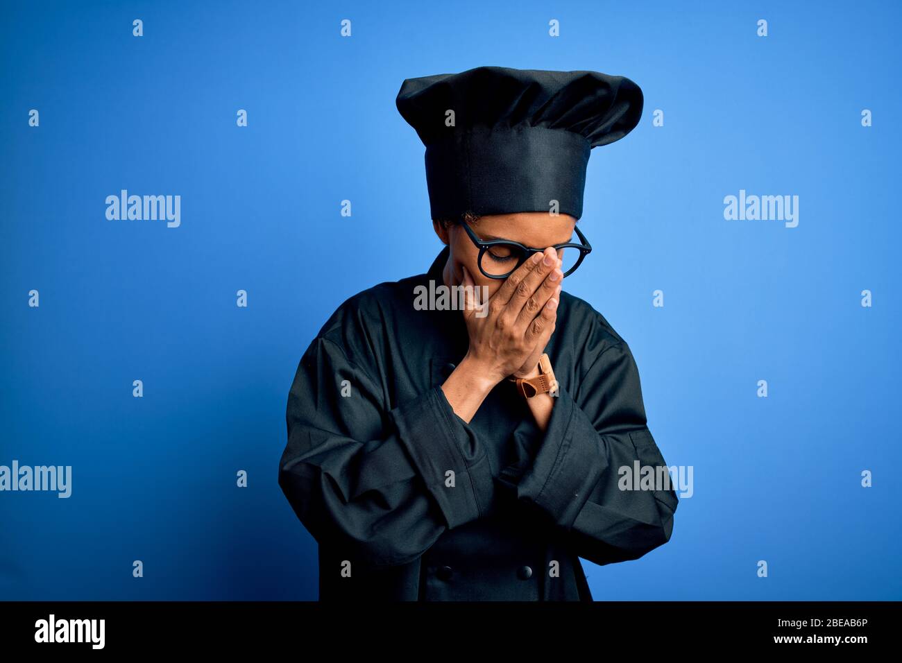 Young african american chef woman wearing cooker uniform and hat over ...