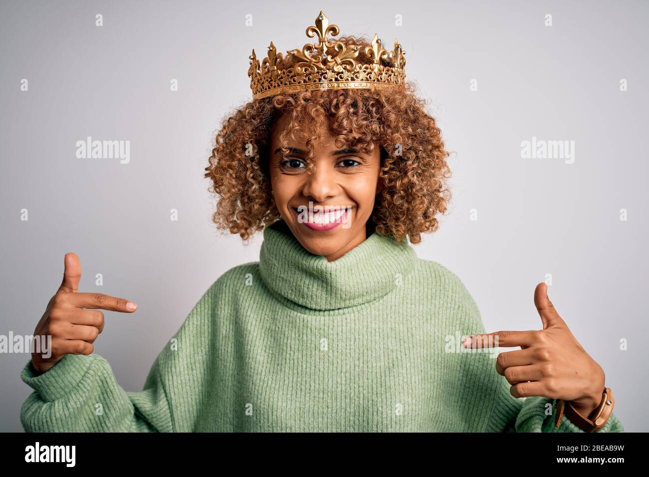 Young african american woman wearing golden crown of queen over ...