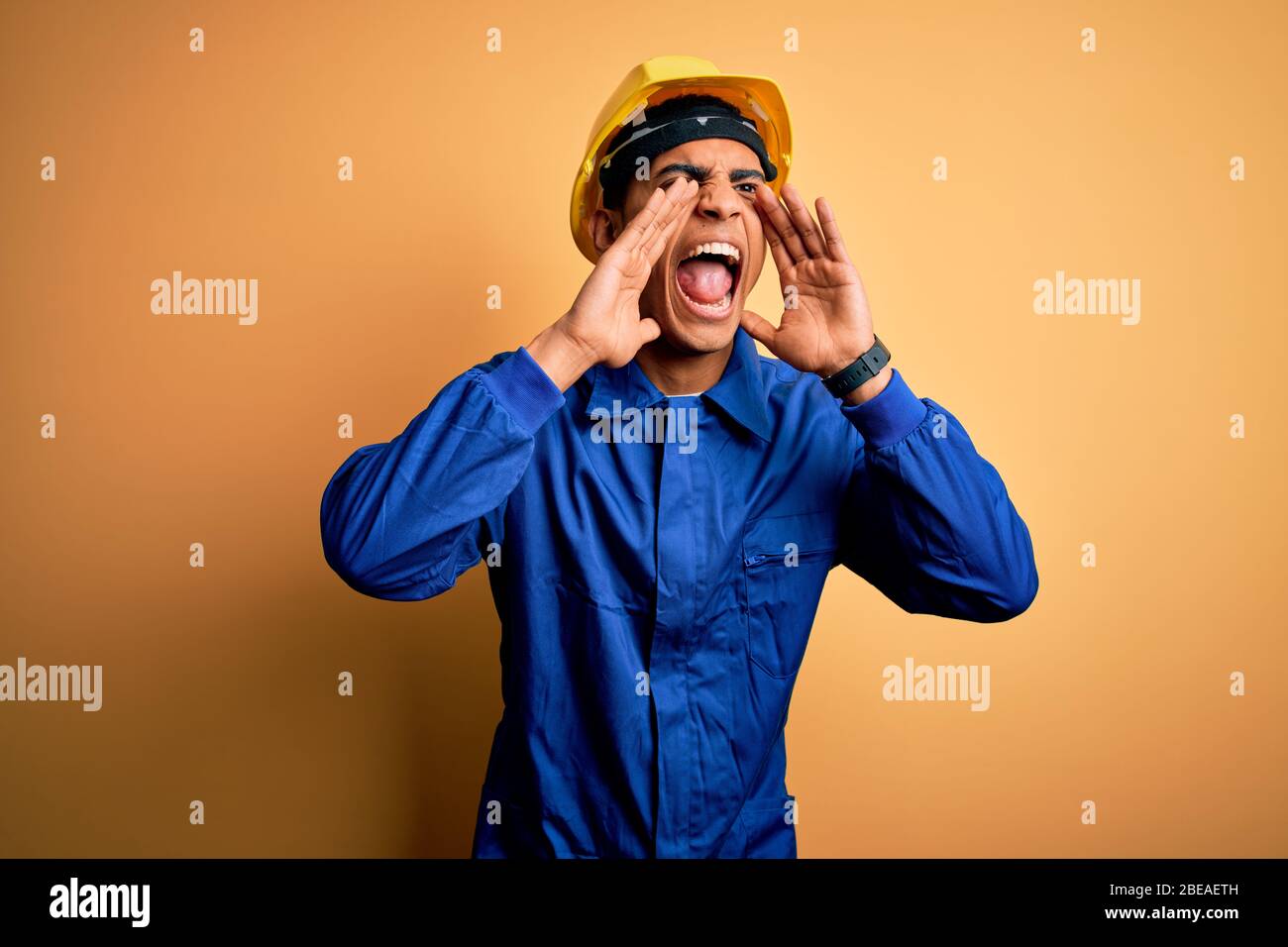 Young handsome african american worker man wearing blue uniform and ...