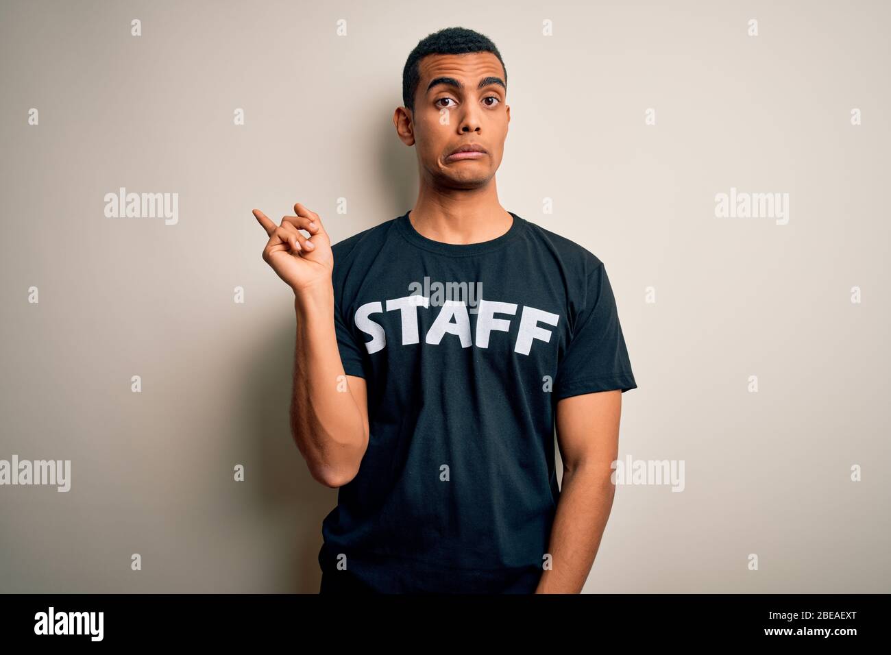 Young handsome african american worker man wearing staff uniform over ...