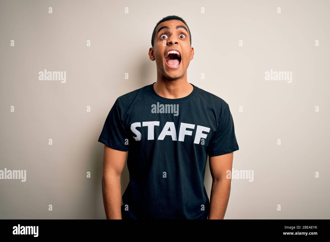 Young handsome african american worker man wearing staff uniform over ...