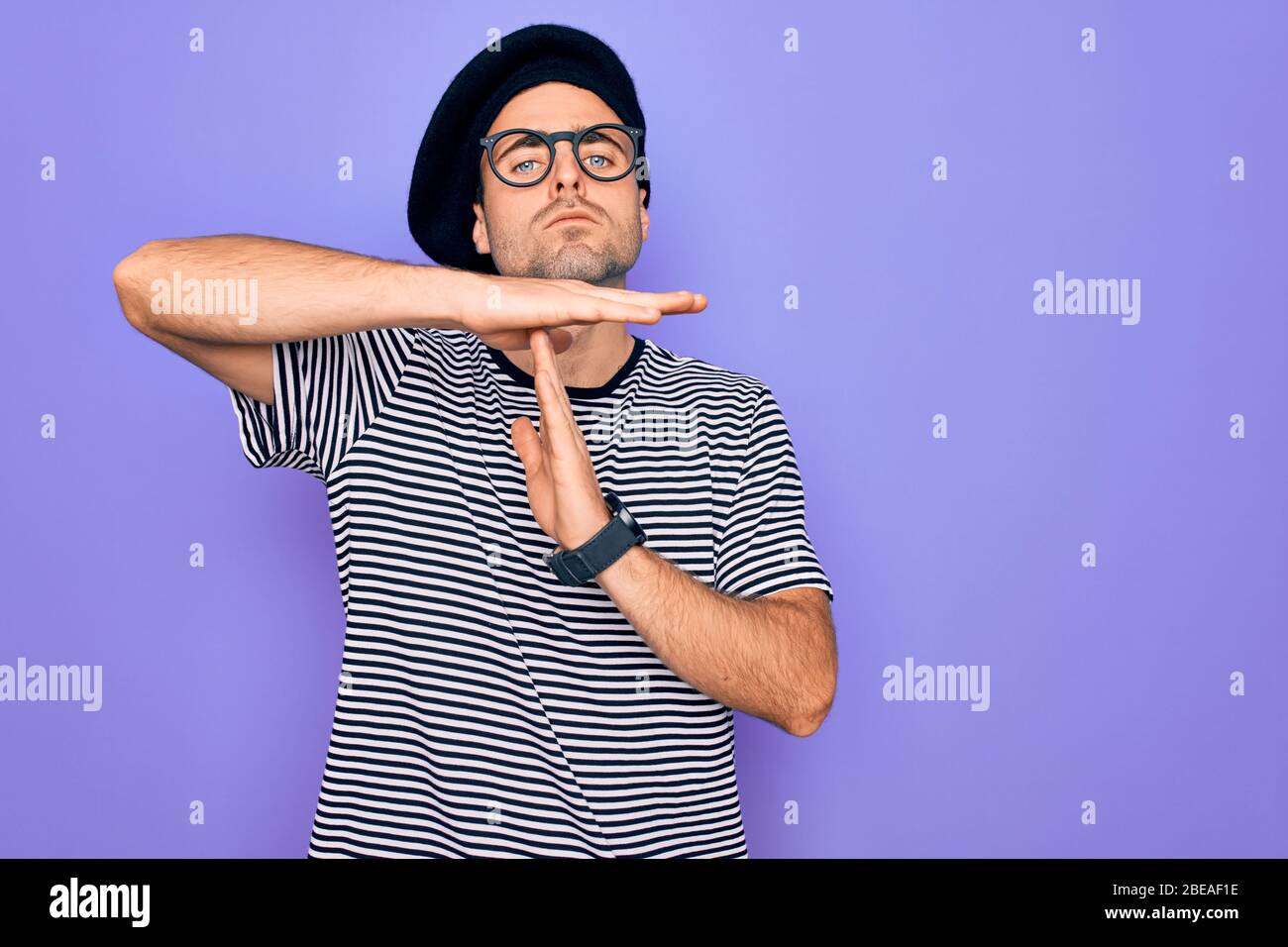 Handsome man with blue eyes wearing striped t-shirt and french beret ...