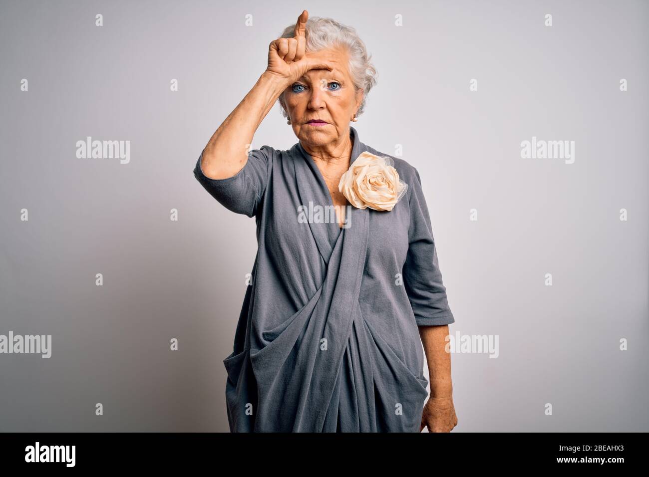 Senior beautiful grey-haired woman wearing casual dress standing over ...