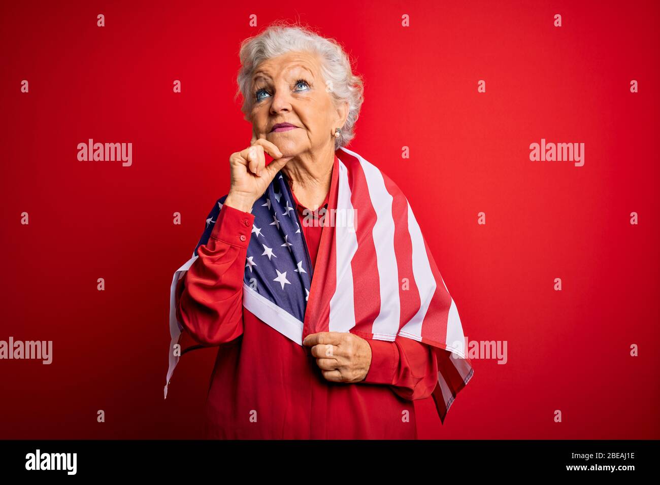 Senior beautiful grey-haired patriotic woman wearing united states flag ...
