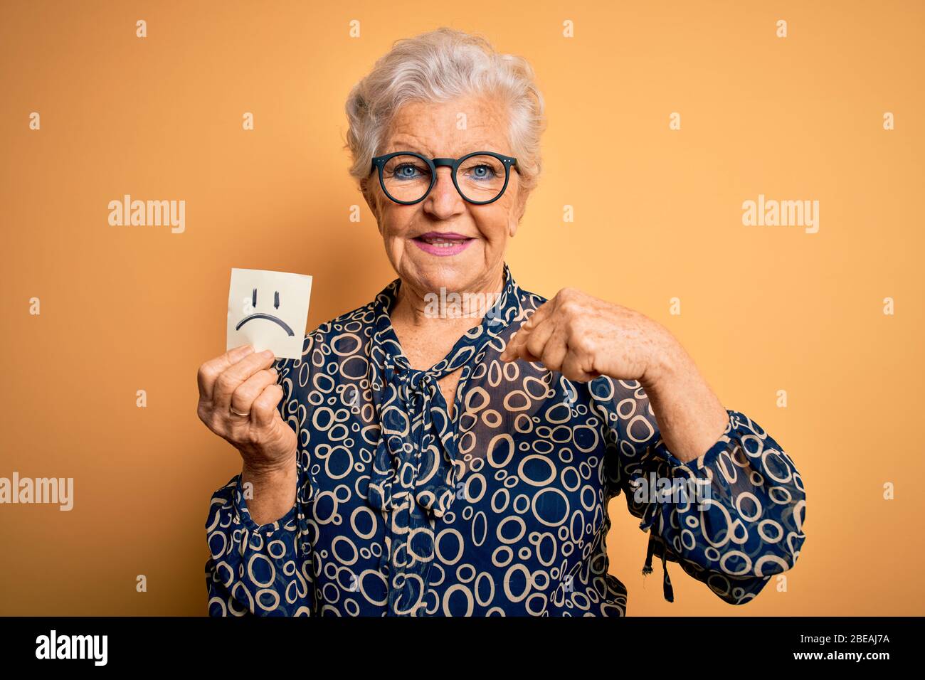 Senior beautiful grey-haired woman holding reminder paper with sad ...