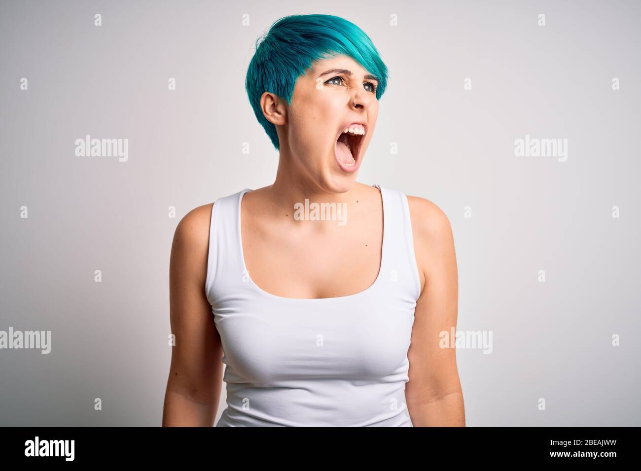 Young beautiful woman with blue fashion hair wearing casual t-shirt ...