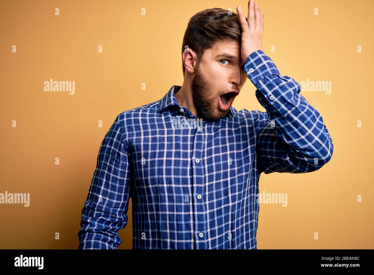 Young blond businessman with beard and blue eyes wearing shirt over ...