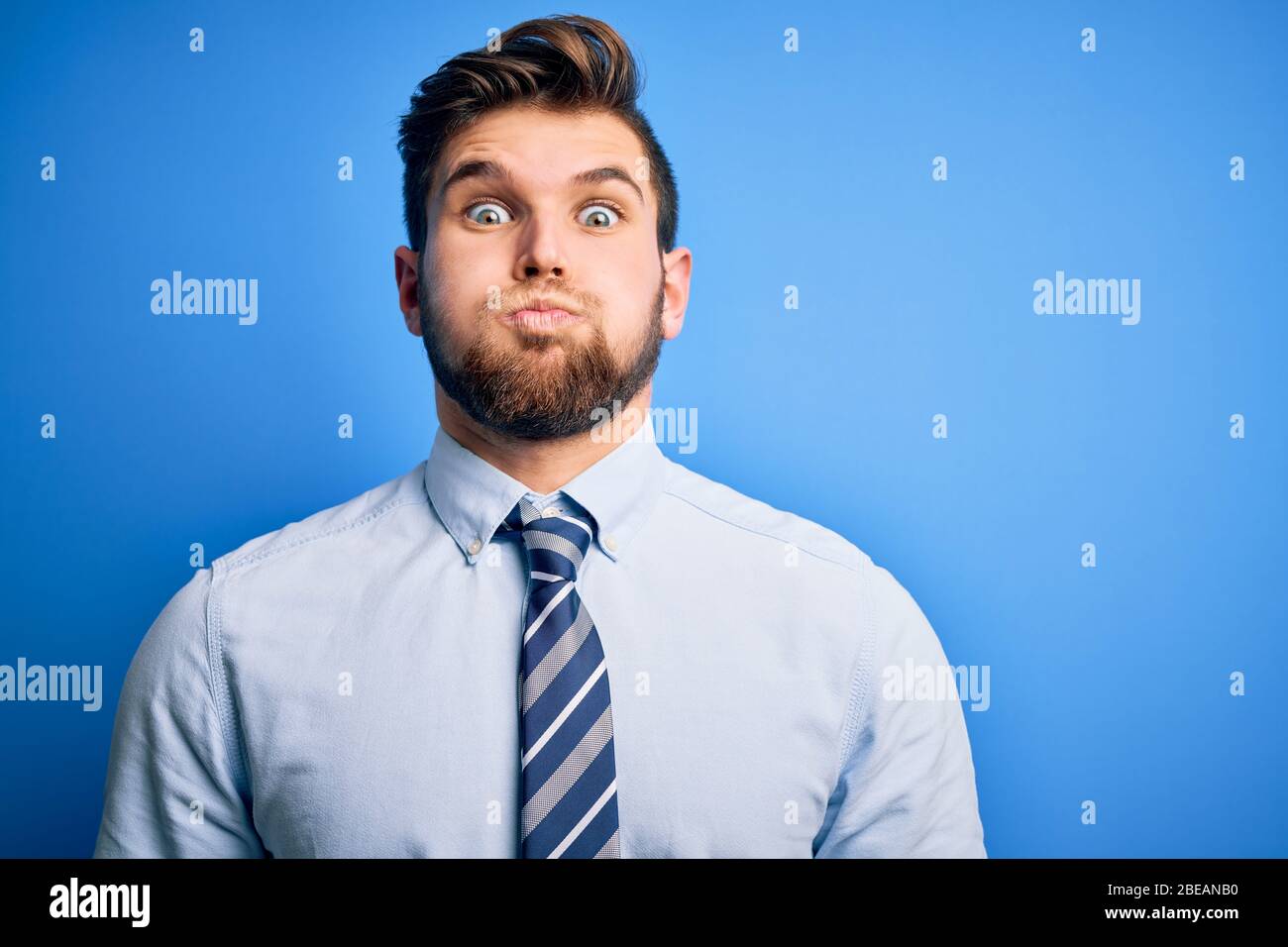 Young blond businessman with beard and blue eyes wearing elegant shirt ...