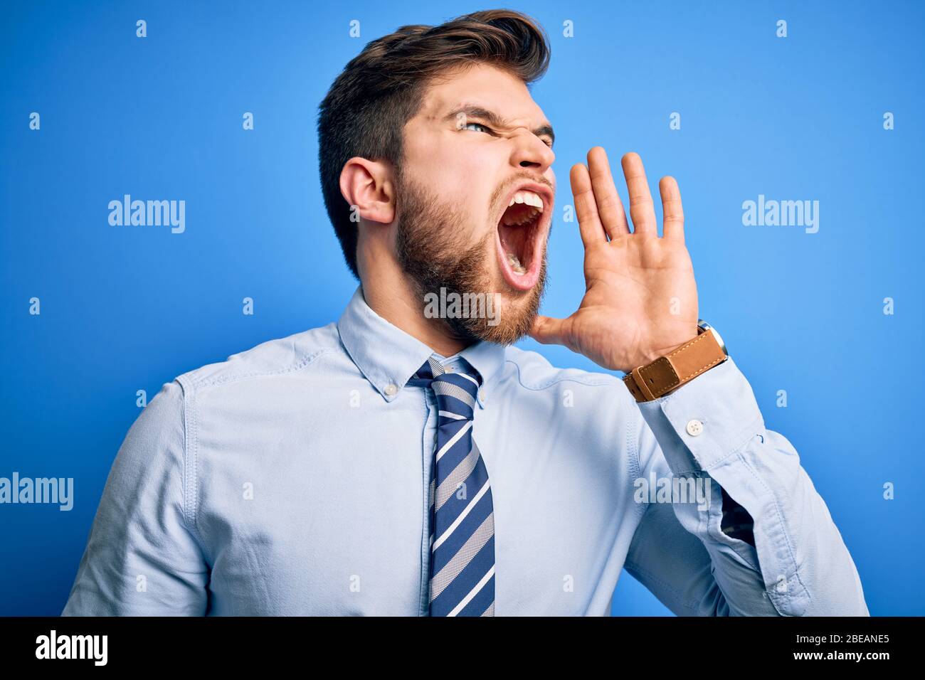 Young blond businessman with beard and blue eyes wearing elegant shirt ...