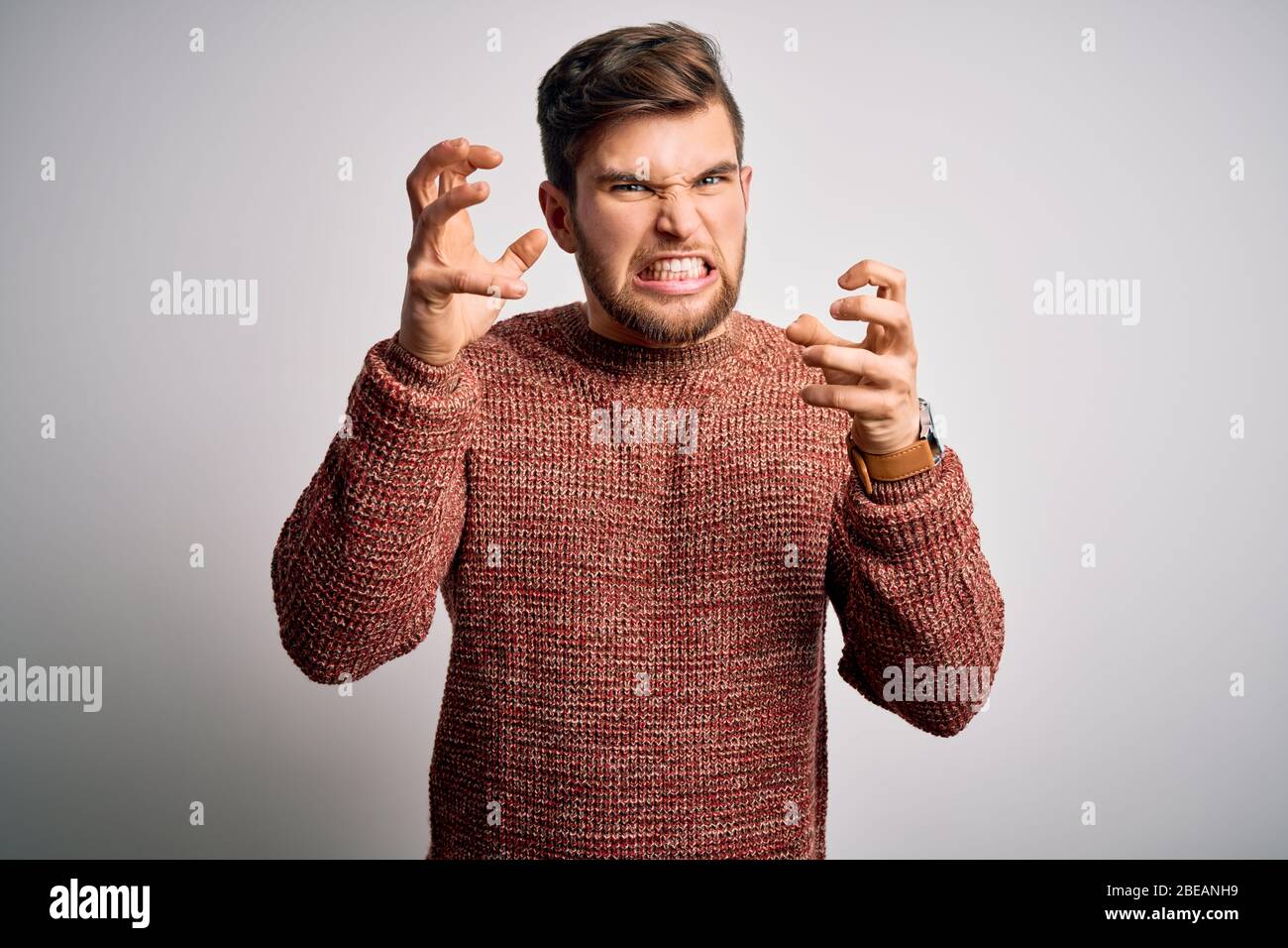 Young blond man with beard and blue eyes wearing casual sweater over ...