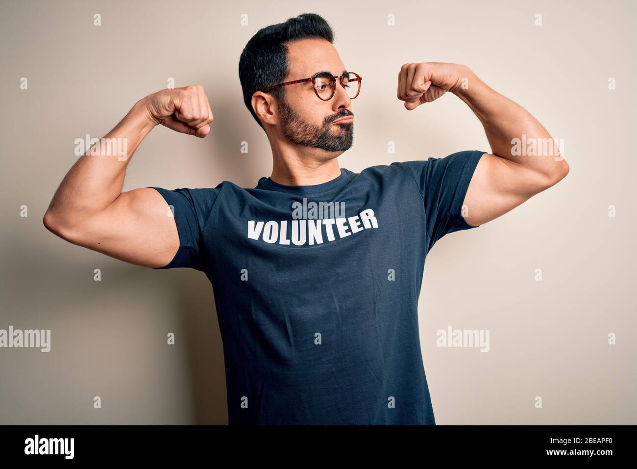 Handsome man with beard wearing t-shirt with volunteer message over ...