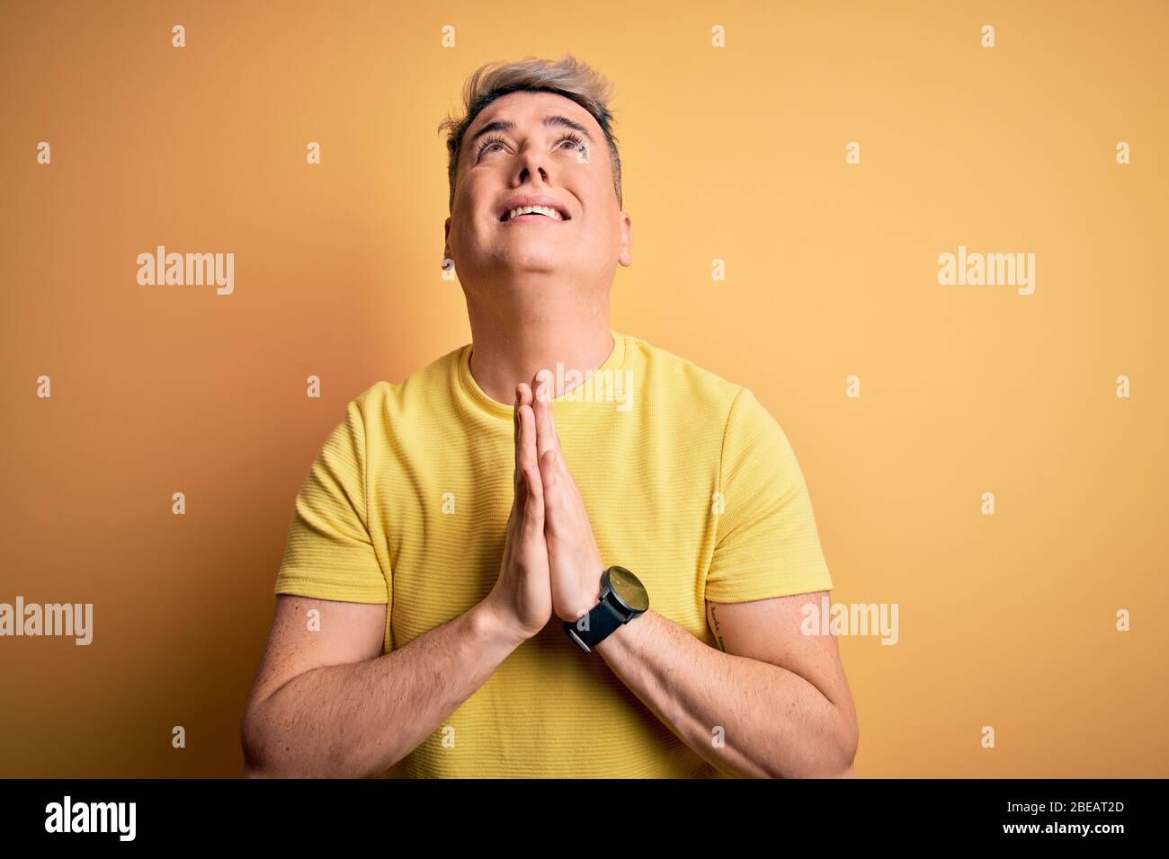 Young handsome modern man wearing yellow shirt over yellow isolated ...