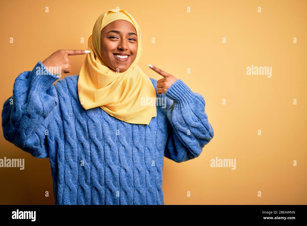 Young African American afro woman wearing muslim hijab over isolated ...
