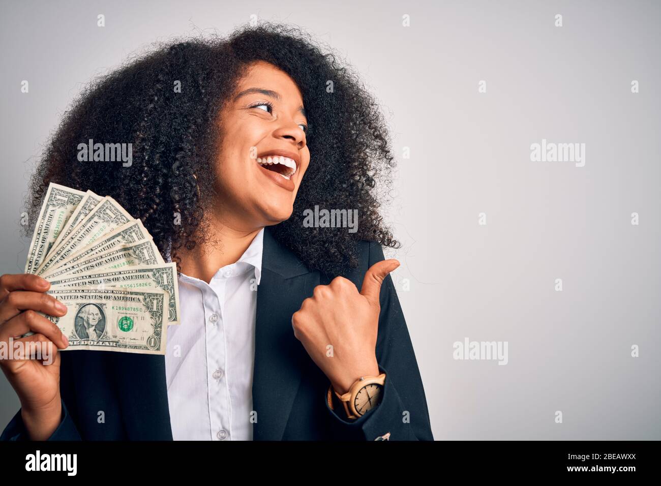 Young african american business woman with afro hair holding cash ...