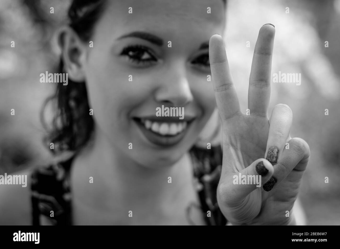 Victory Sign. Young woman doing victory sign with the hand. Happy girl ...