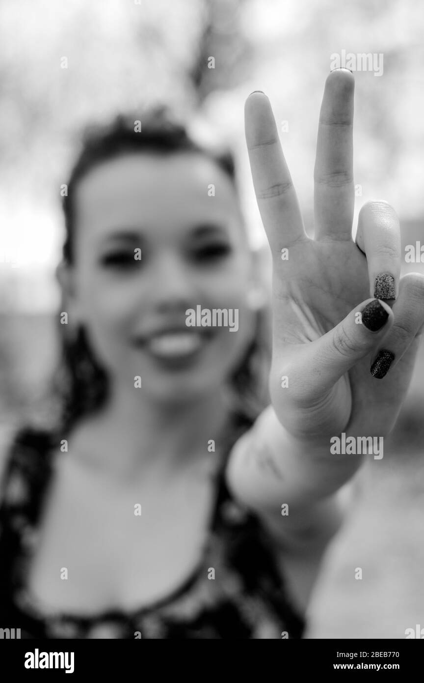 Victory Sign. Young woman doing victory sign with the hand. Happy girl ...