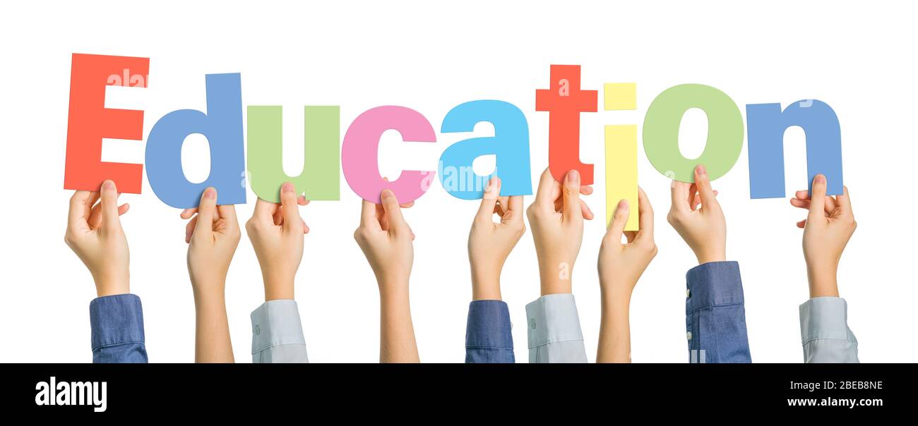 Multiple hands holding alphabets to form the word Education on white ...