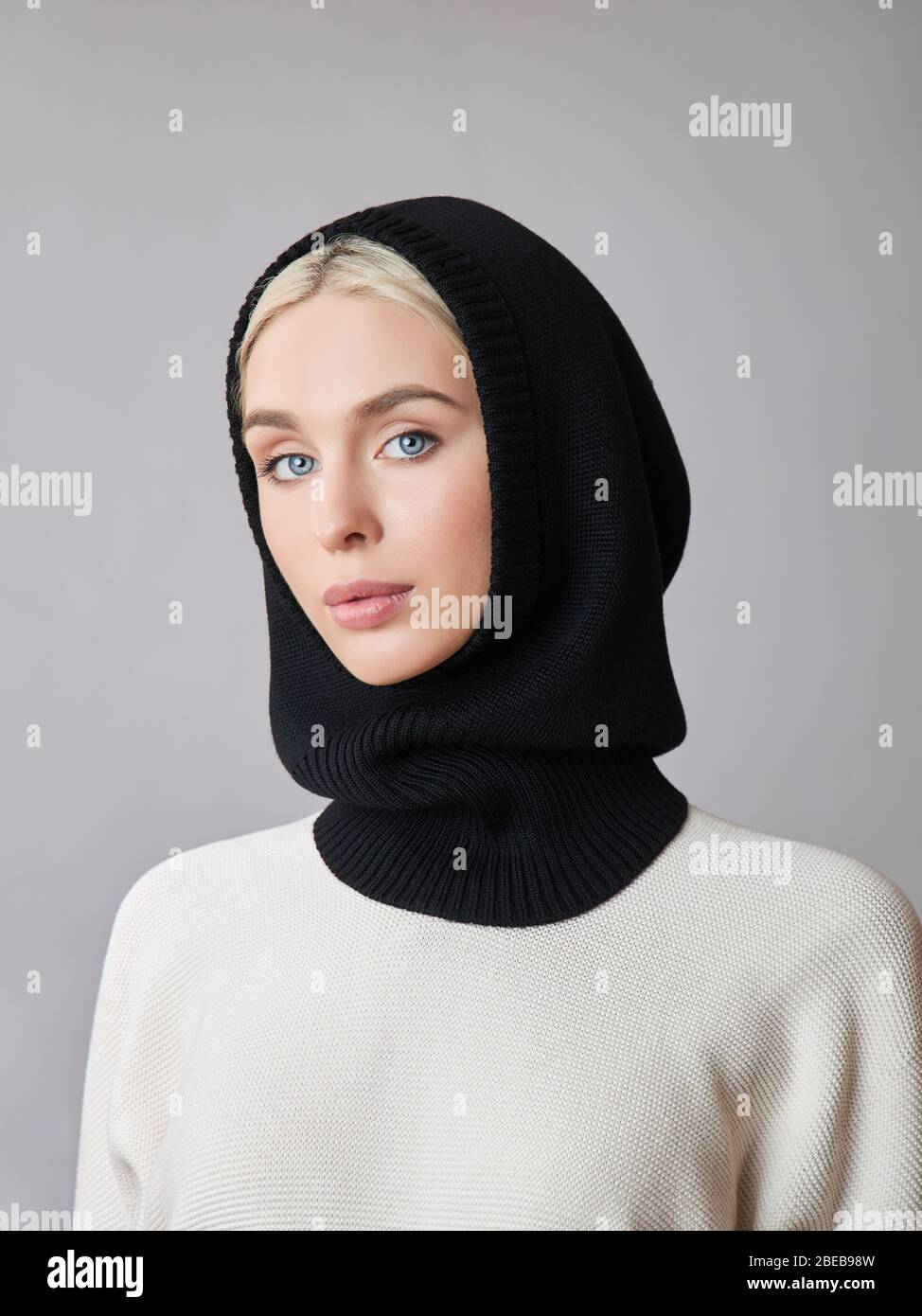 European Muslim woman with a blonde hair in a bonnet hood dressed on ...