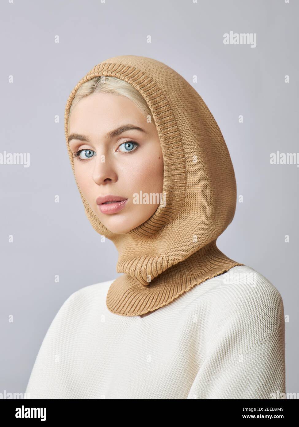 European Muslim woman with a blonde hair in a bonnet hood dressed on ...