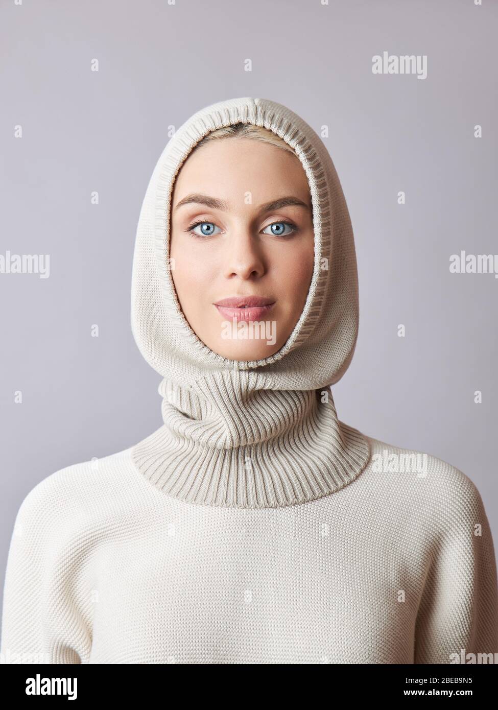 European Muslim woman with a blonde hair in a bonnet hood dressed on ...