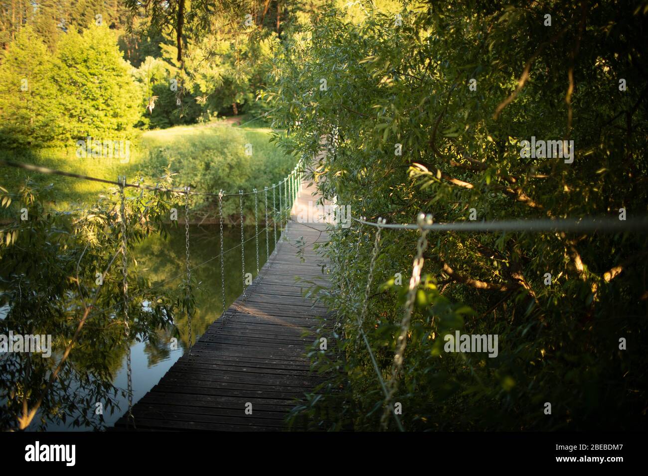 Beautiful long suspension bridge over the river Stock Photo - Alamy