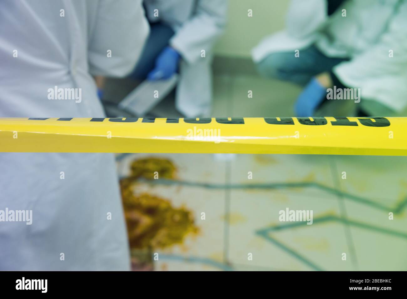 Forensic technicians taking DNA sample from blood stain with cotton ...