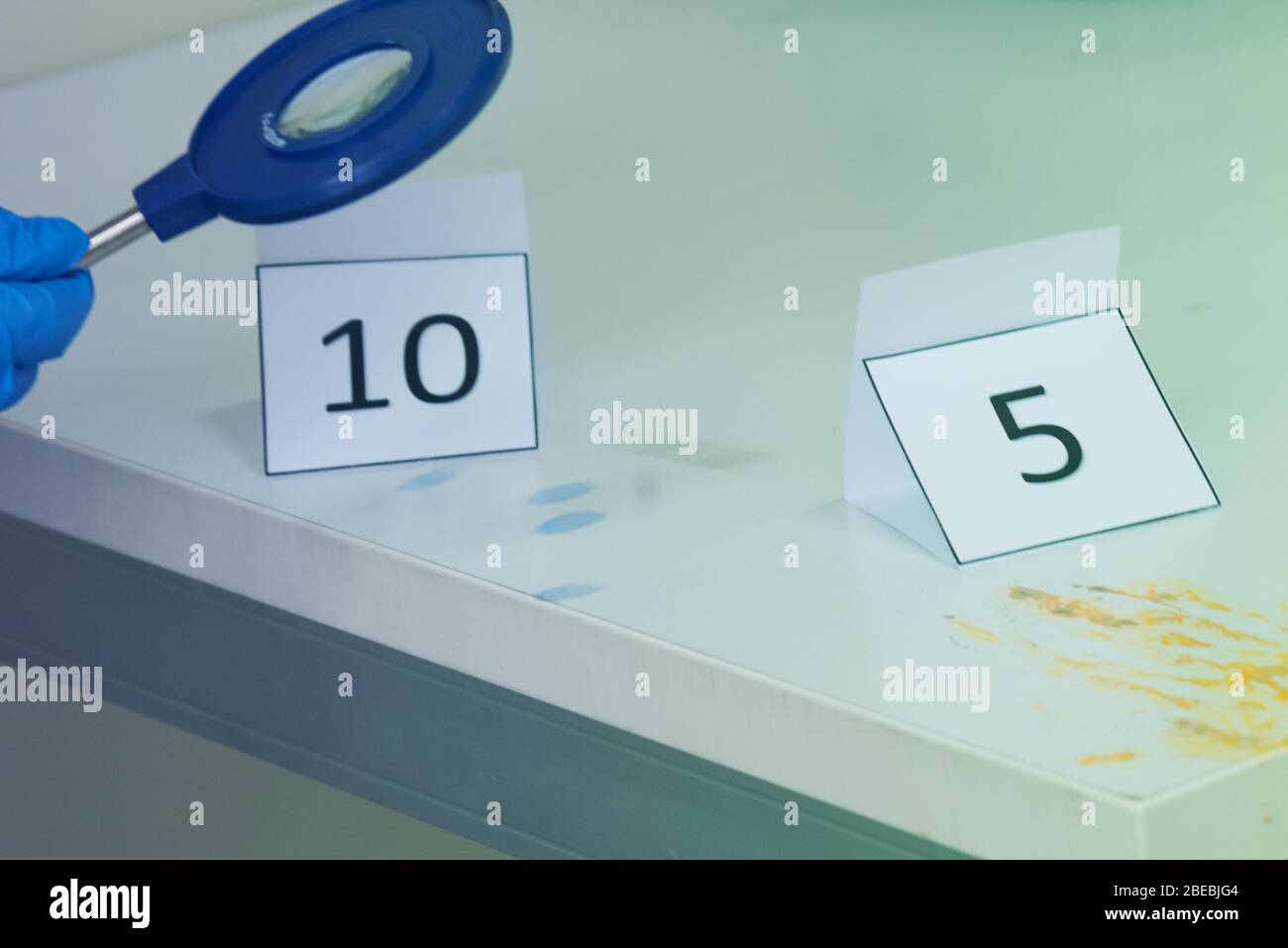 Forensic technicians taking DNA sample from blood stain with cotton ...