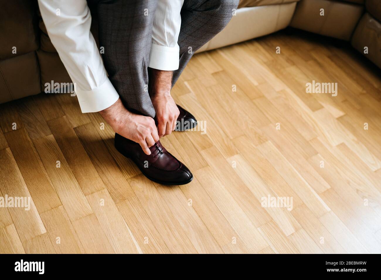 businessman putting on shoes, man getting ready for work, groom morning ...