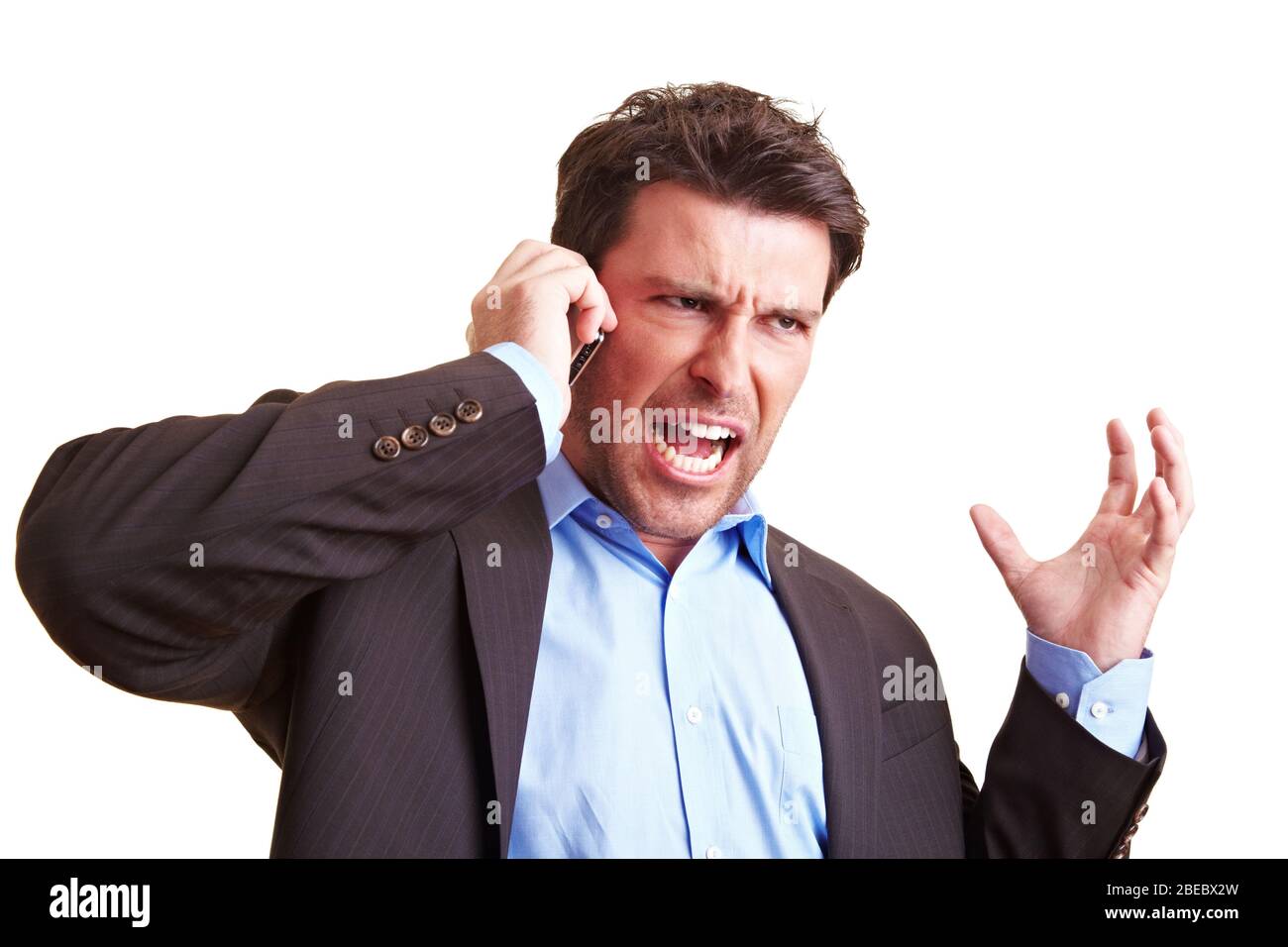 Angry businessman is talking on his cell phone Stock Photo - Alamy