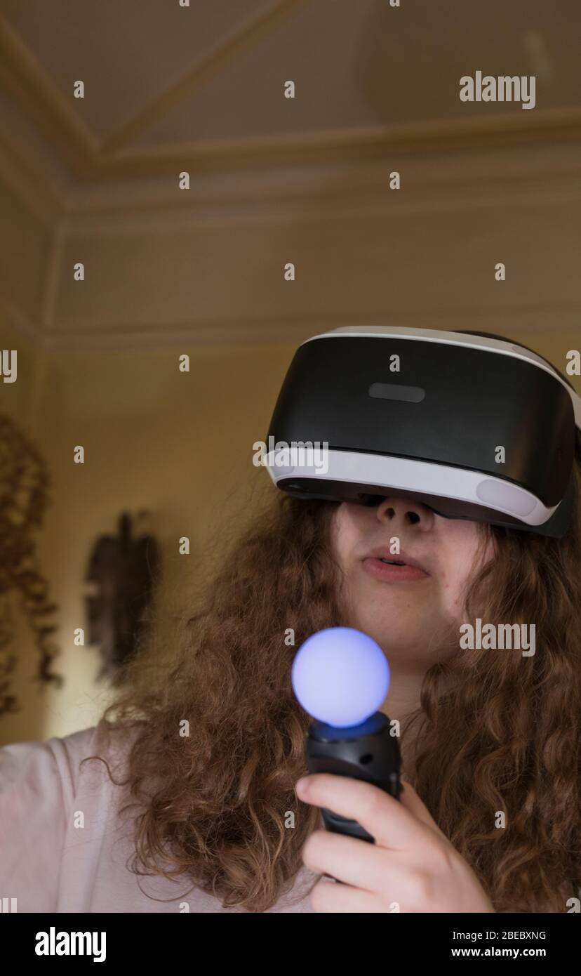 Girl playing virtual game with headset at home. London, England Stock ...