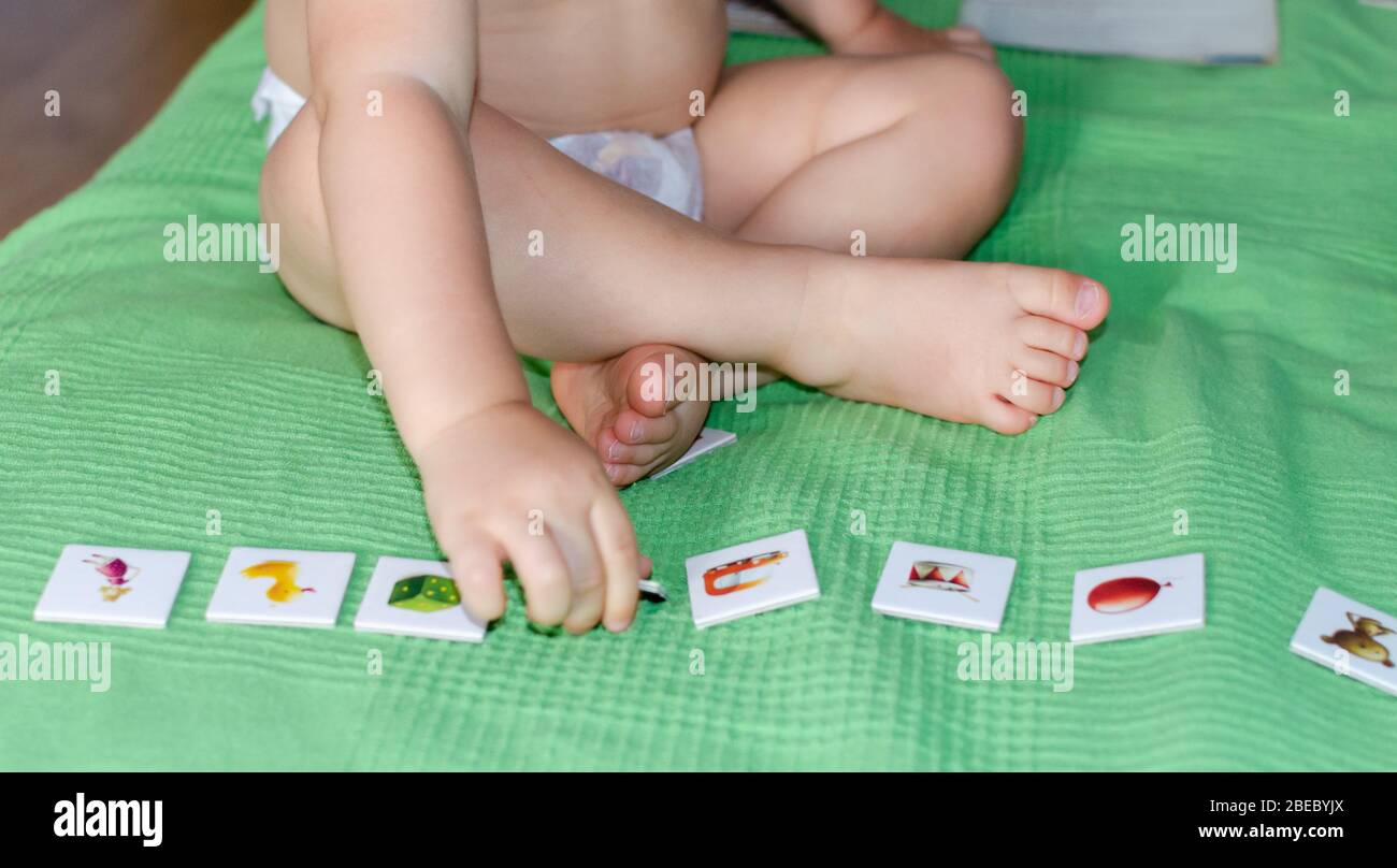 Child lining up toys on the floor at home. Kids education concept Stock ...