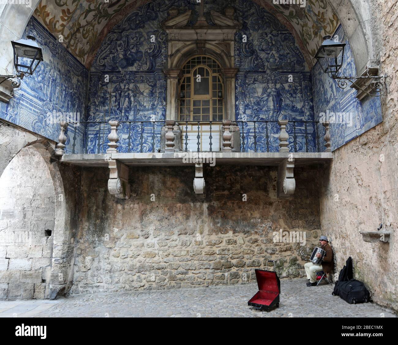 Azulejo and a busker in the city gate of Obidos, a medieval town that ...