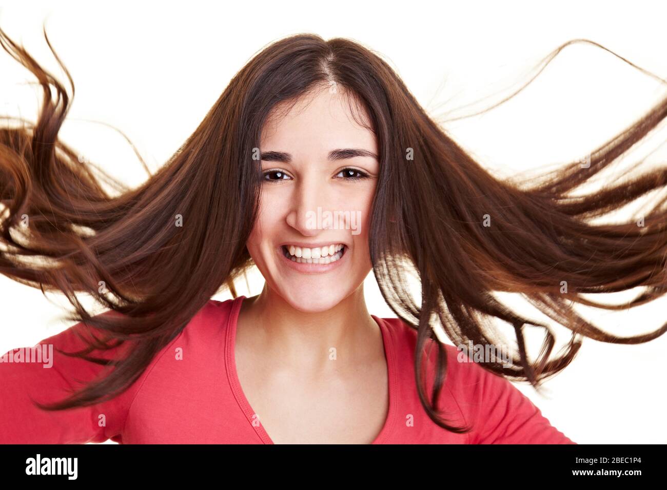Laughing young woman with long flying hair Stock Photo - Alamy