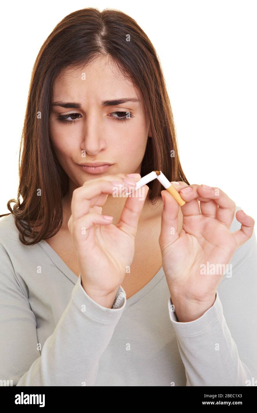Young woman breaks a cigarette in half Stock Photo - Alamy