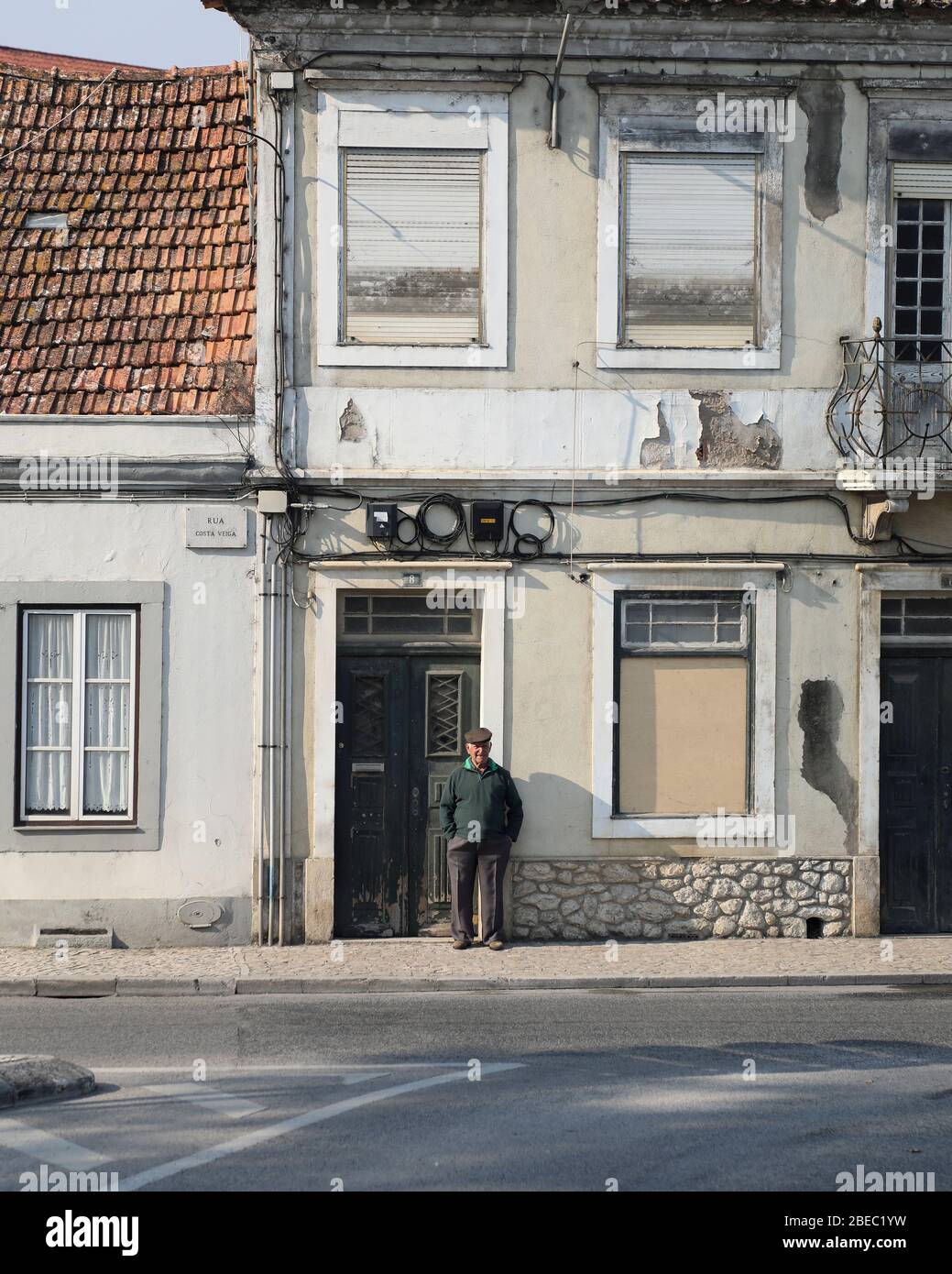 A man stands in front of a traditional Portuguese building in the ...