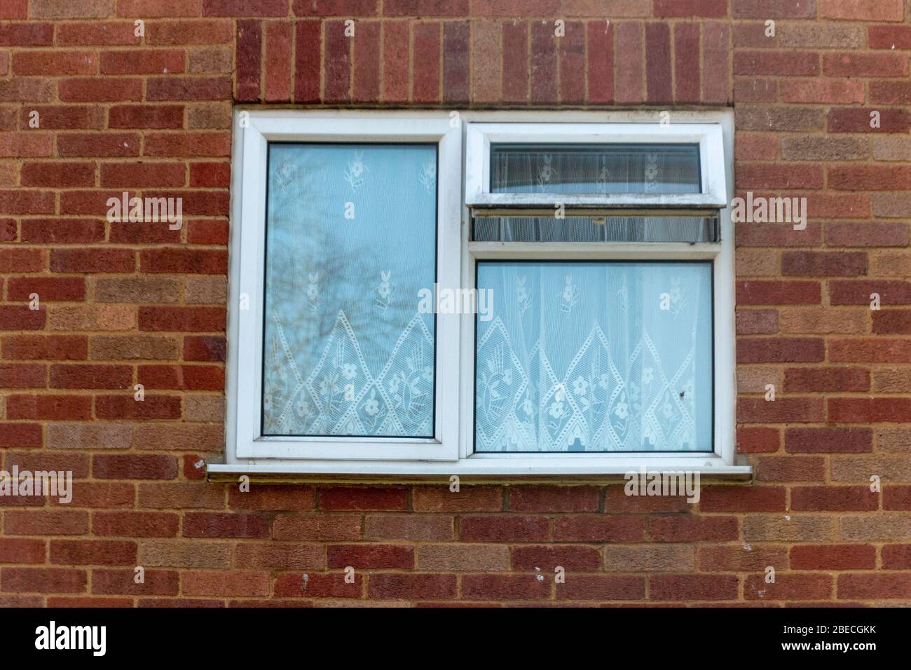 a close up view of a small side window on a brick face buliding with ...