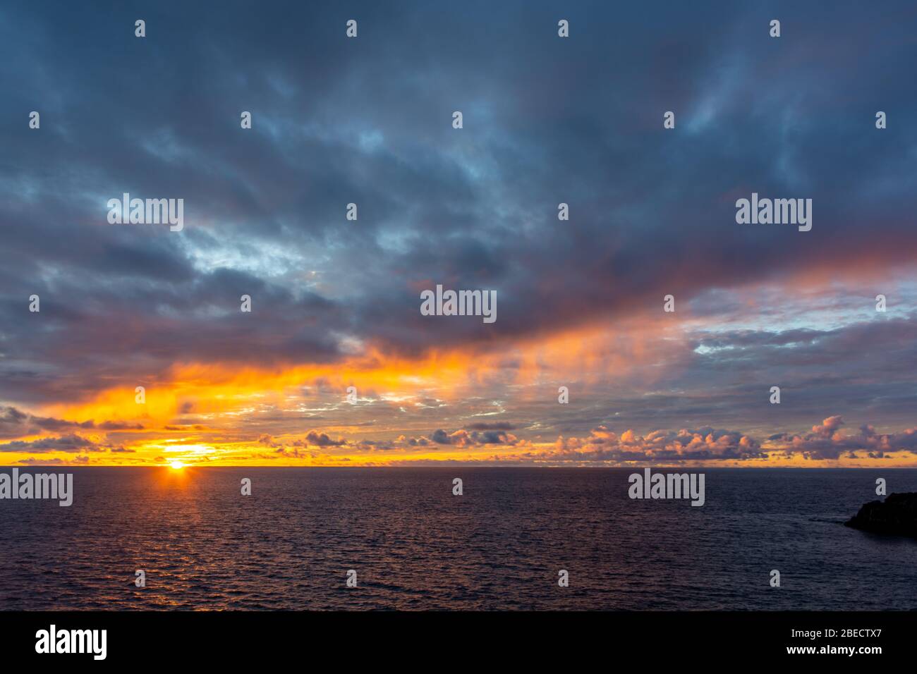 Amazing sunset with colorful cloudscape and dark ocean water, nature ...