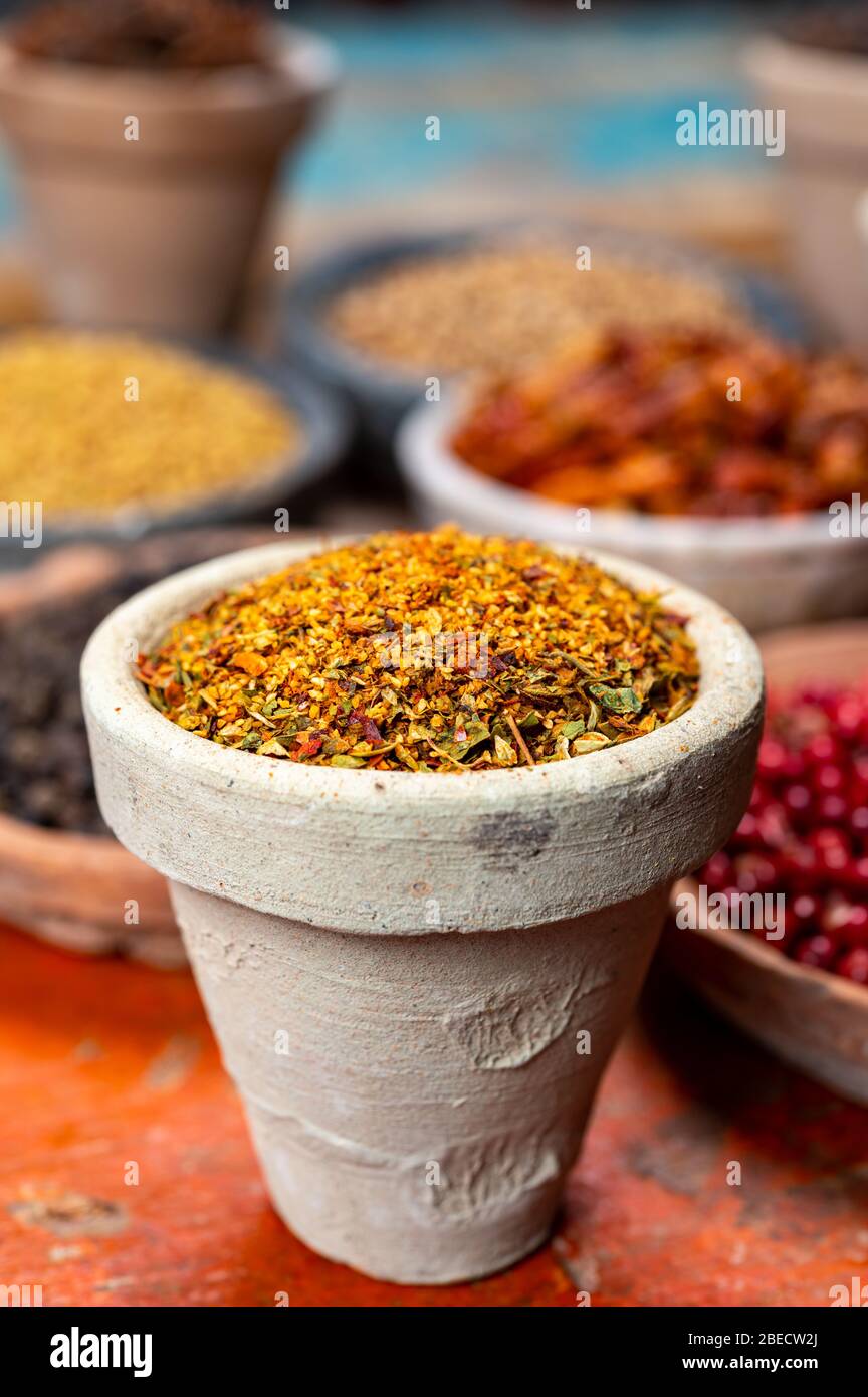 Indian spices collection, dried herbs and another spices in clay bowls ...